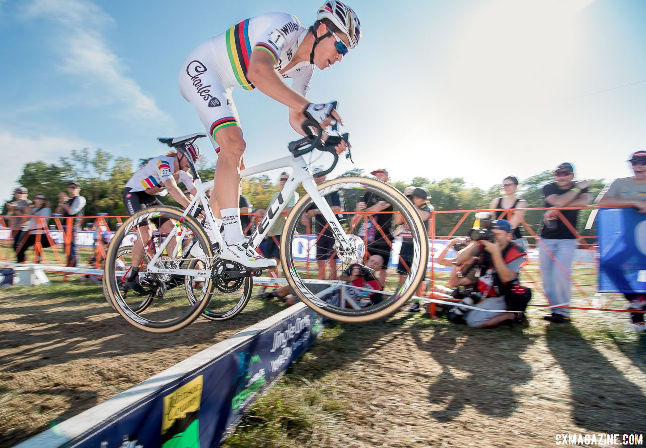 Stripes in flight: Wout van Aert leads Stephen Hydeover the barriers ...